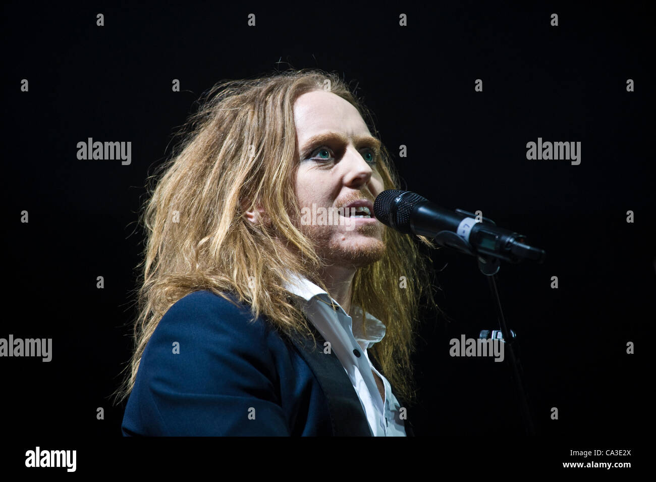 Tim Minchin, comedian and musician, performing on stage with his band ...
