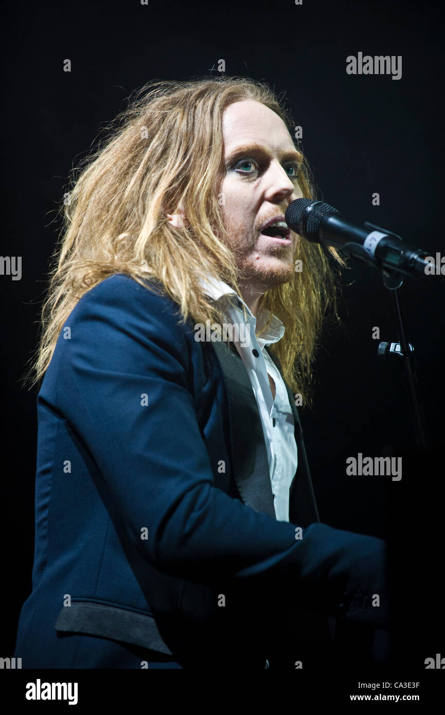 Tim Minchin, comedian and musician, performing on stage with his band ...