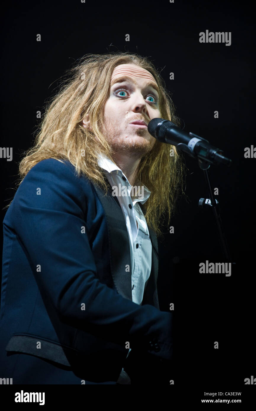 Tim Minchin, comedian and musician, performing on stage with his band ...