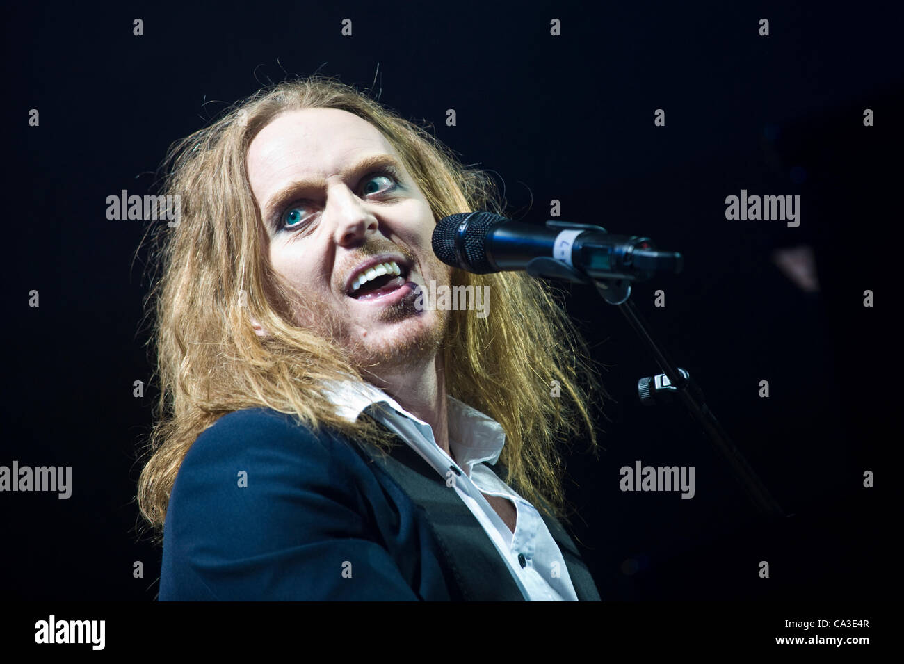 Tim Minchin, comedian and musician, performing on stage with his band ...