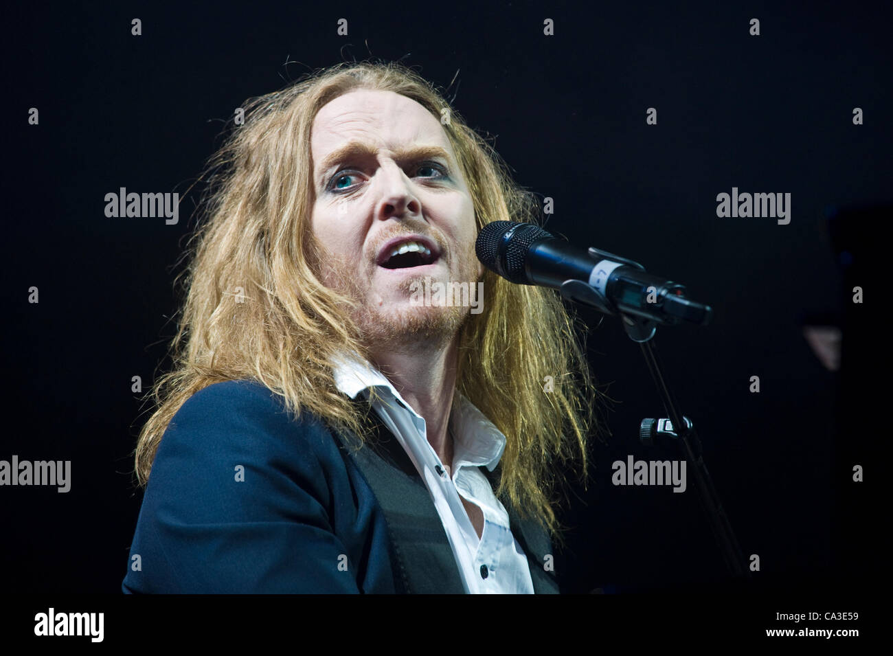 Tim Minchin, comedian and musician, performing on stage with his band ...