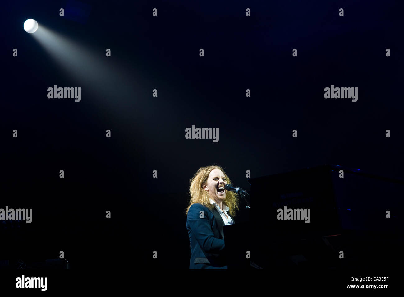 Tim Minchin, comedian and musician, performing on stage with his band ...