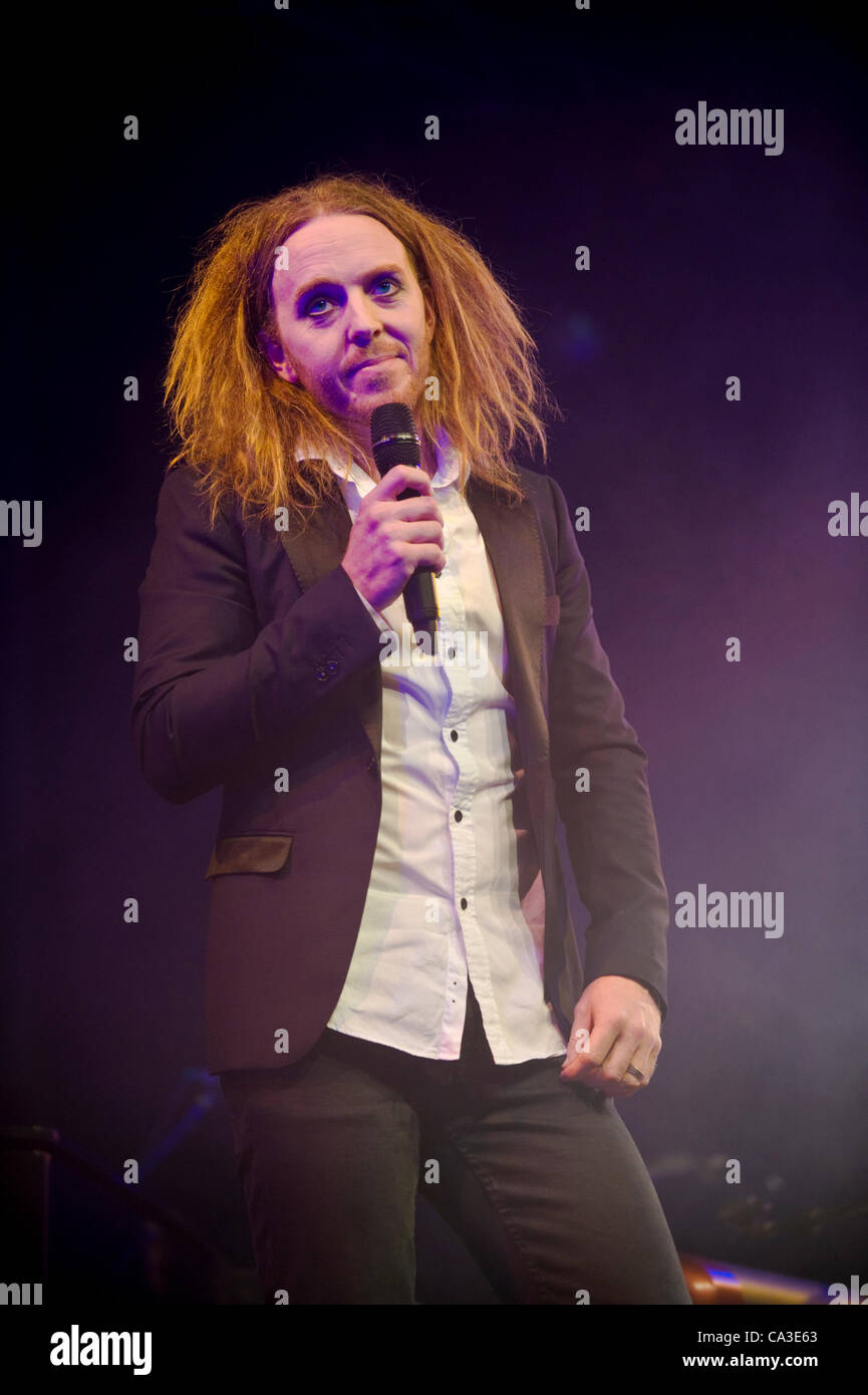 Tim Minchin, comedian and musician, performing on stage with his band ...