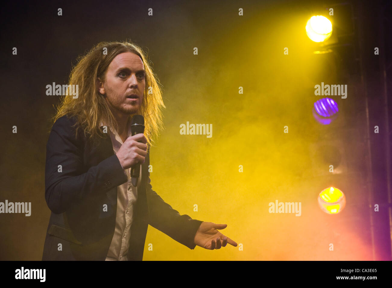 Tim Minchin, comedian and musician, performing on stage with his band ...