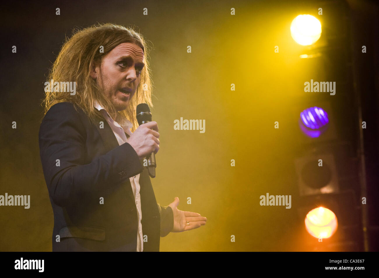 Tim Minchin, comedian and musician, performing on stage with his band ...