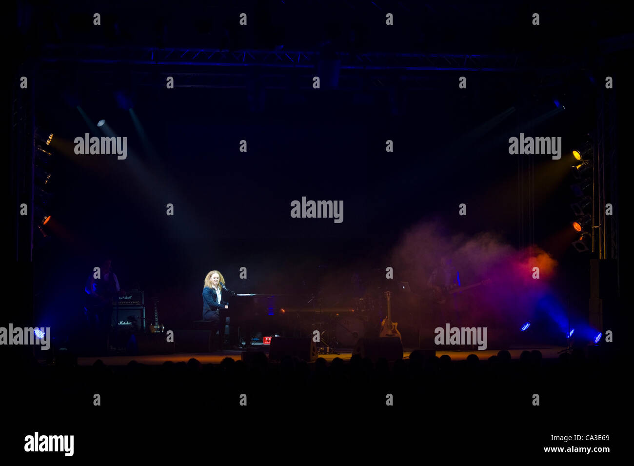 Tim Minchin, comedian and musician, performing on stage with his band ...
