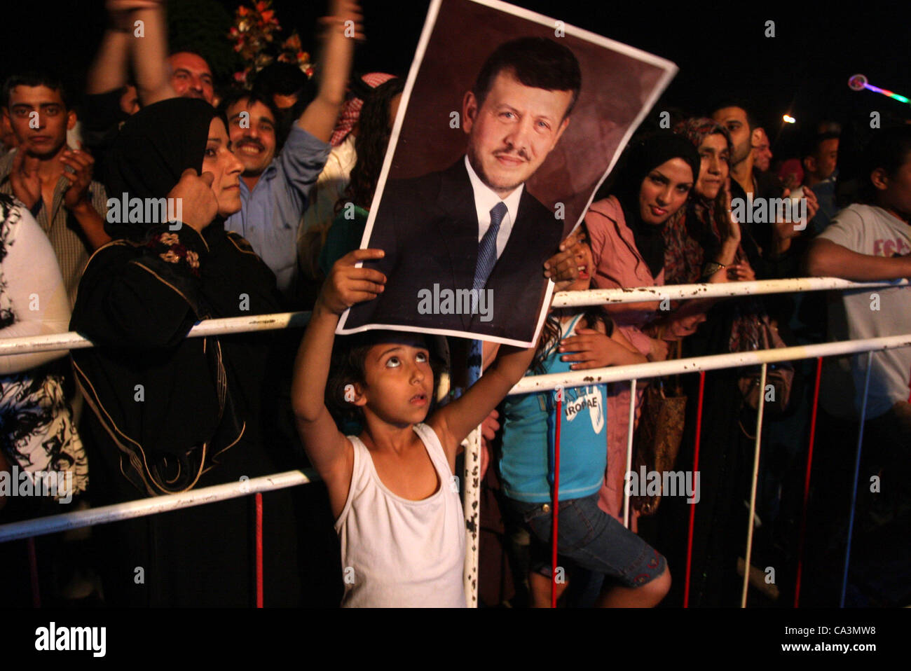 June 1, 2012 - Amman, Jordan - A boy holds up a portrait of the Jordan ...