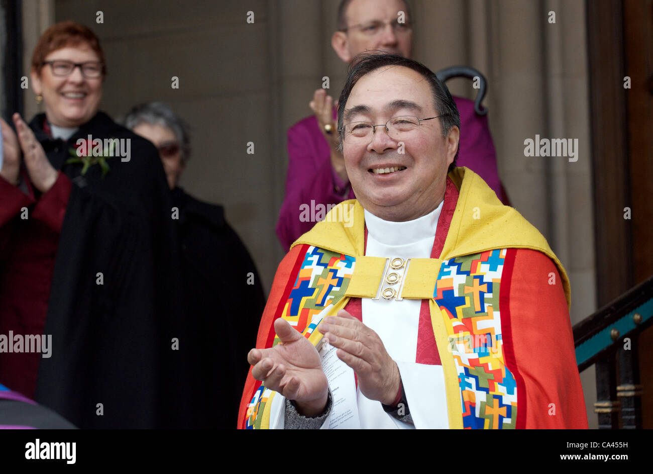 Reverend Canon Roy Chow leads the clapping during the the service held ...