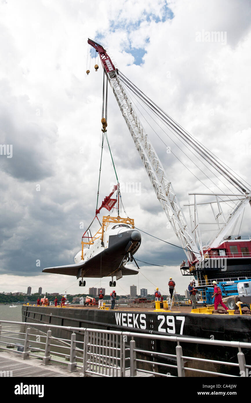 crane lifts space shuttle Enterprise clear of delivery barge as it ...