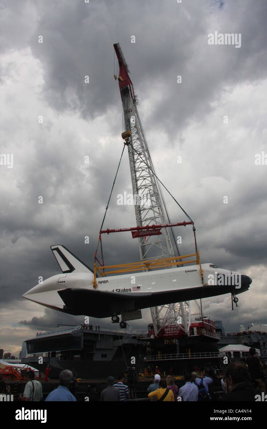 Space Shuttle Enterprise being lifted by a Crane to the Intrepid flight ...
