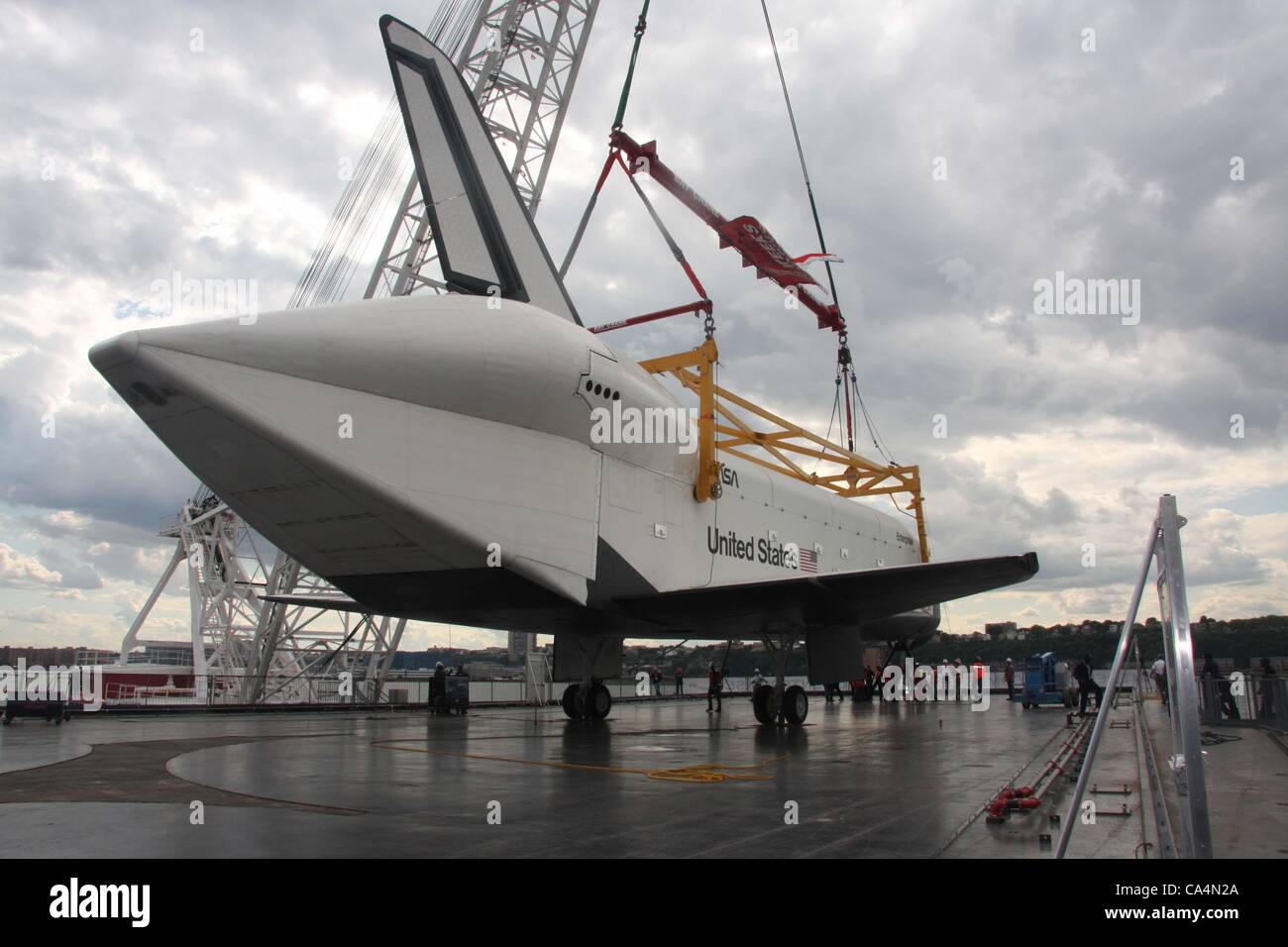 Space Shuttle Enterprise being lifted by a Crane to the Intrepid flight ...
