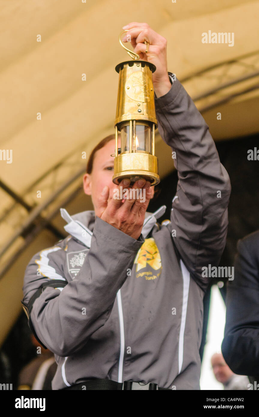 The Olympic Flame in its Davy Lamp lantern is held up Stock Photo - Alamy
