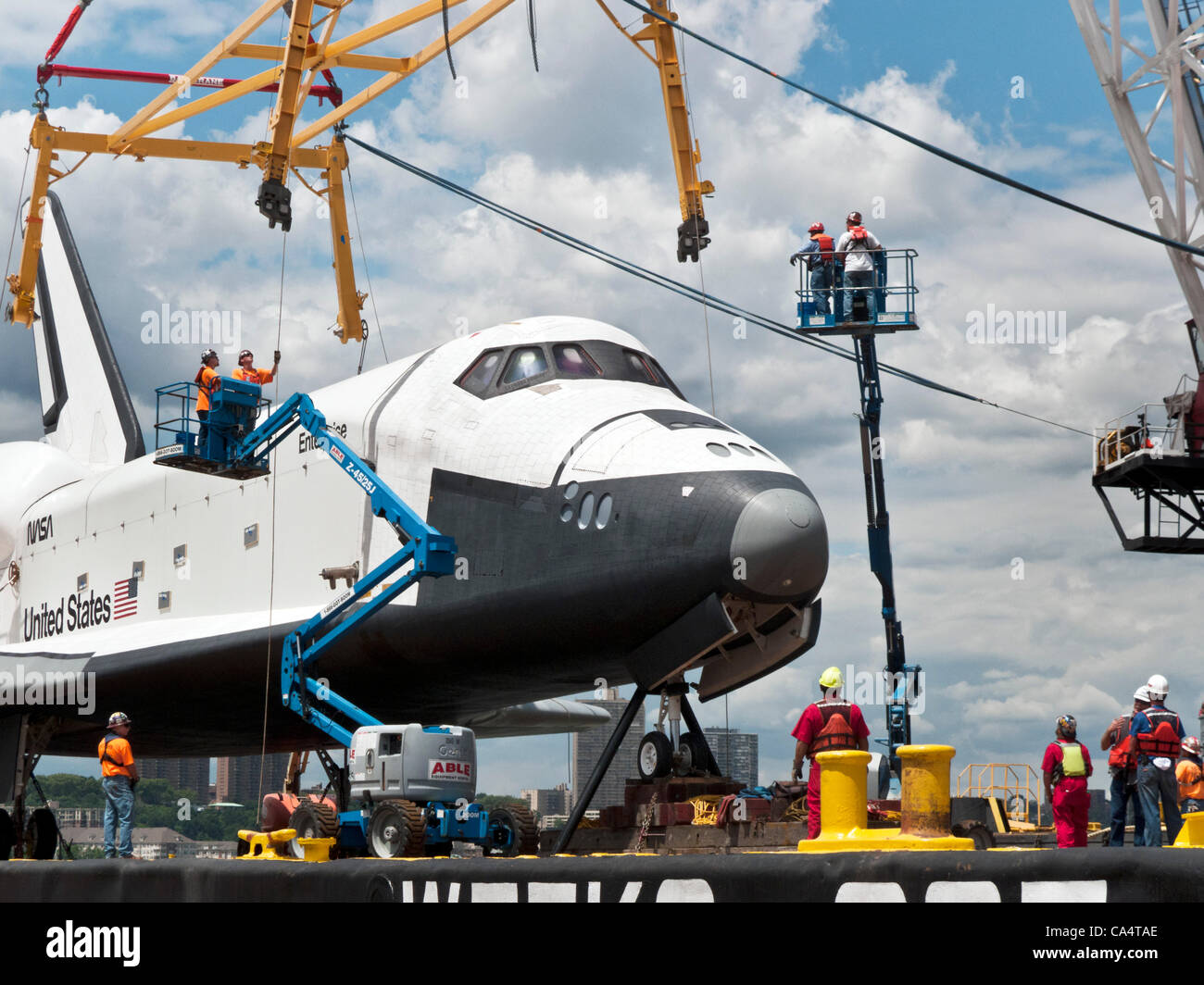 Metal support frame is lowered over space shuttle Enterprise for ...