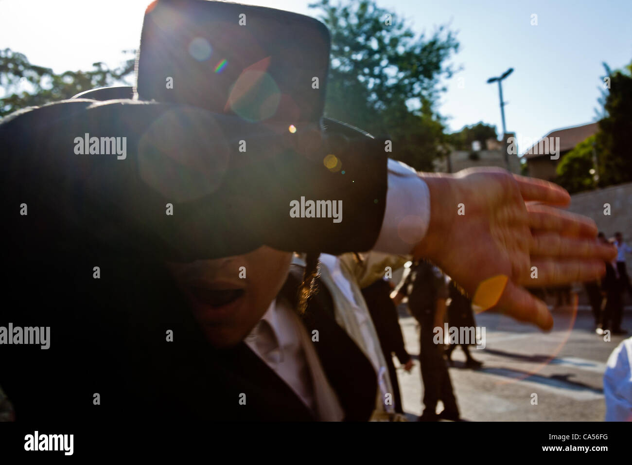 An ultra-Orthodox Haredi man hides his face so not to be photographed ...