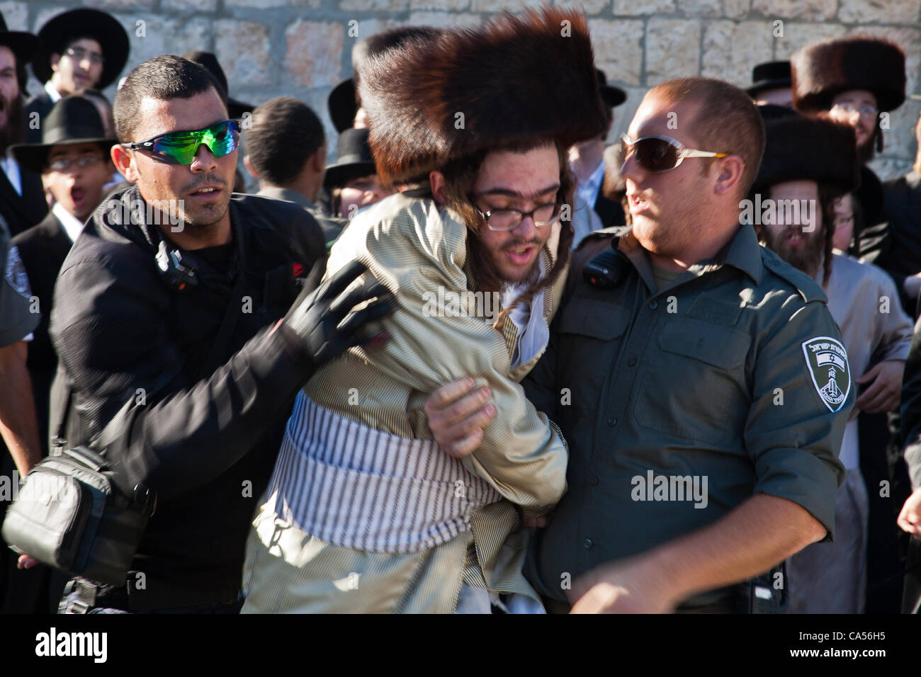 Police arrest an ultra-Orthodox Haredi man during riots and renewed ...