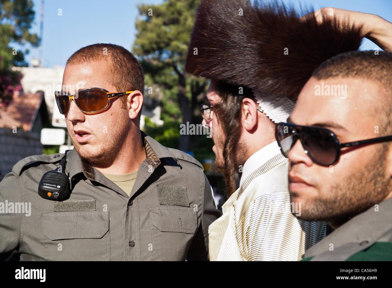 Police arrest an ultra-Orthodox Haredi man during riots and renewed ...