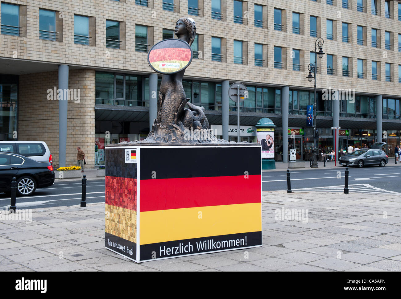 Mermaid (symbol of Warsaw) statue with German flag standing in Warsaw ...