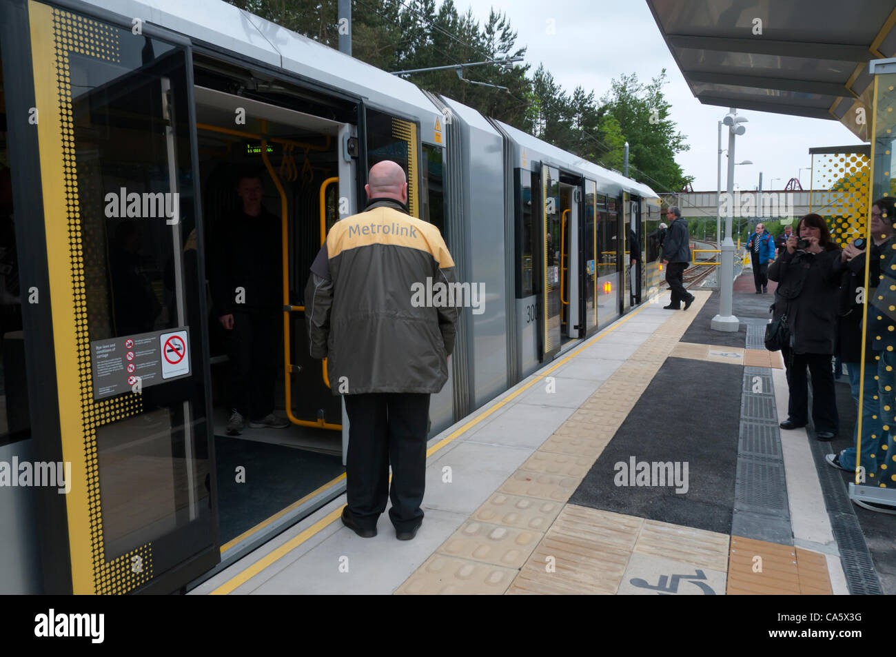13 June 2012. A Metrolink employee at the Oldham Mumps tram stop ...