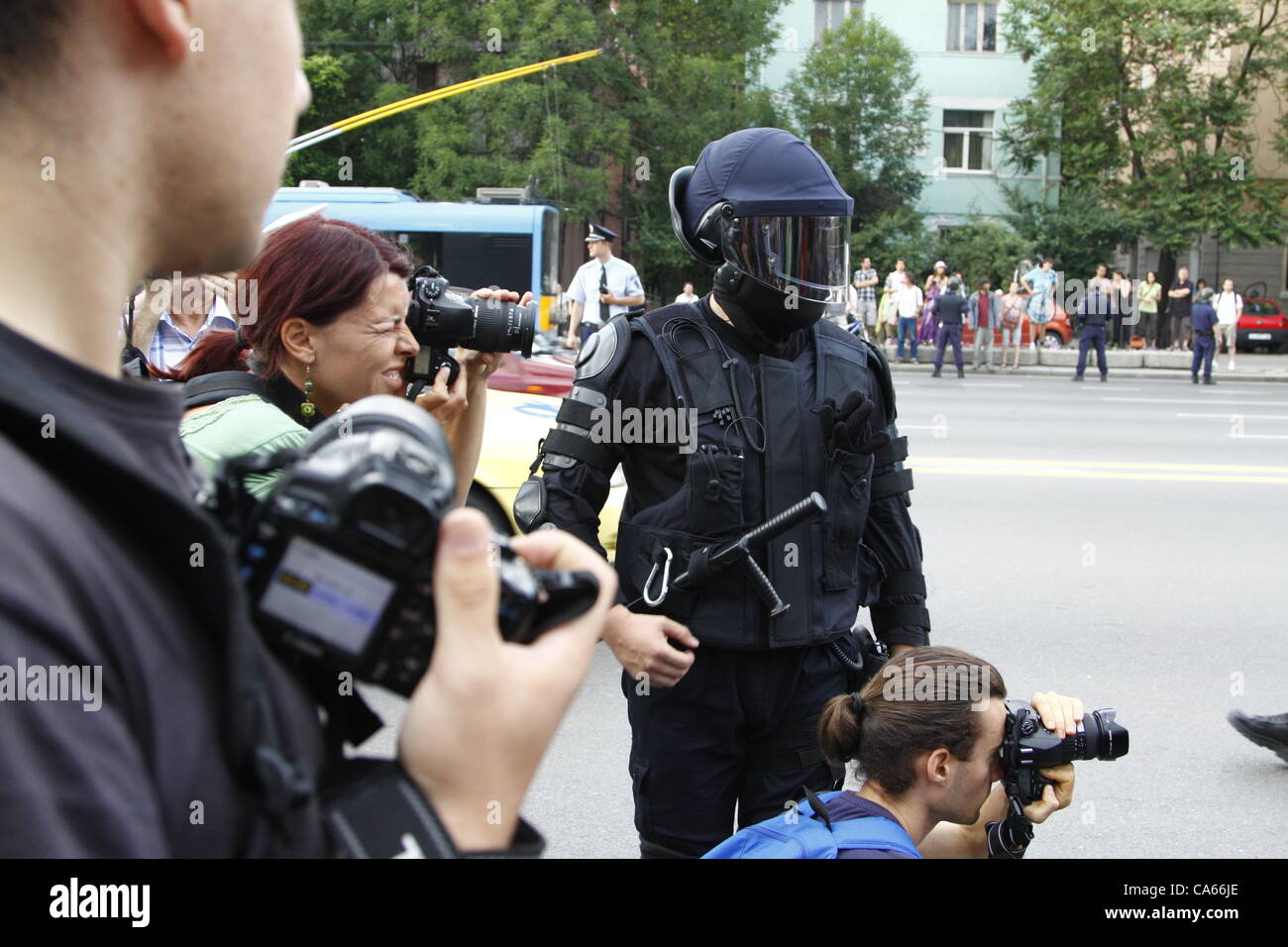 Riot police and photographers following the movements of the ...