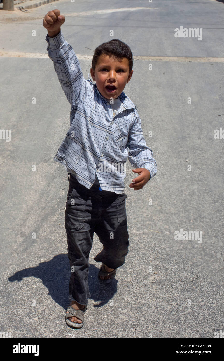 A young Syrian boy demonstrates in the street against the Assad regime ...