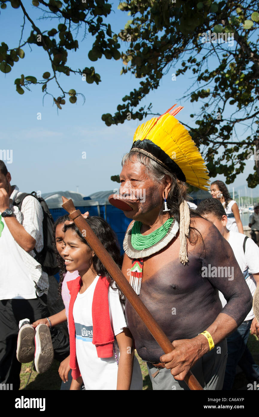 Kayapo Chief Raoni carries his warclub and walks with a group of ...