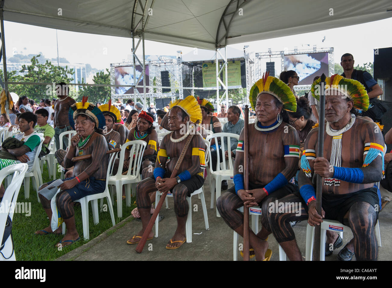 A group of Kayapo indigenous warriors are watching a presentation by ...