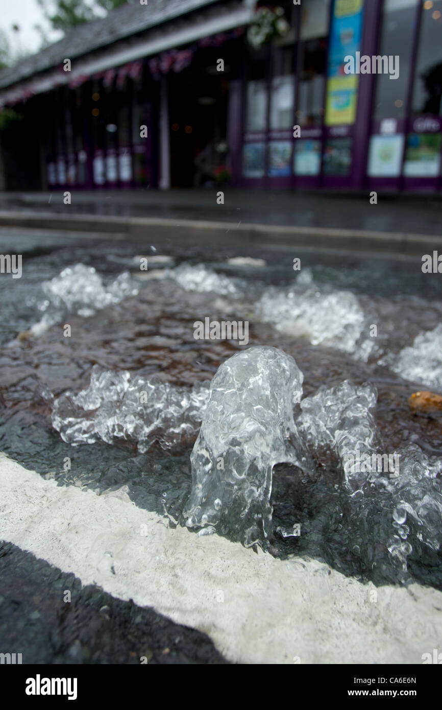 Drain overflowing outside tourist information office Stock Photo - Alamy
