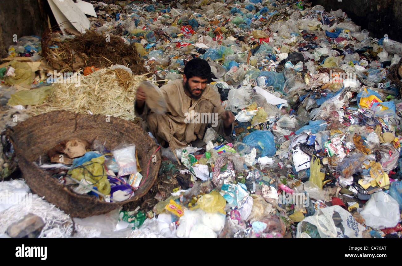 Afghan refugee, who collects garbage, searches useful items to earn his ...