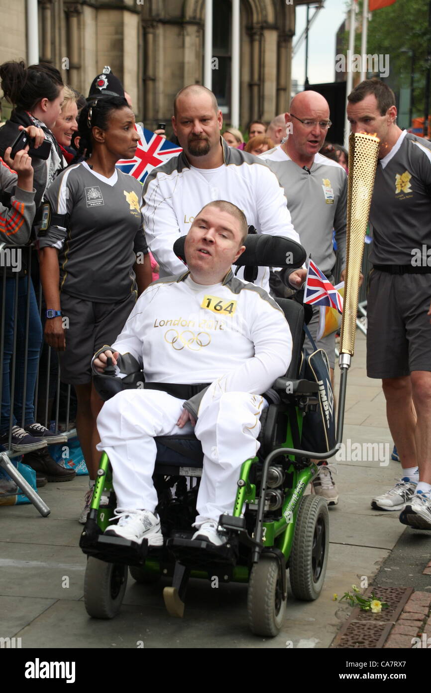 Manchester, UK. 23 June, 2012. Carl Tilson lights the Olympic beacon in ...