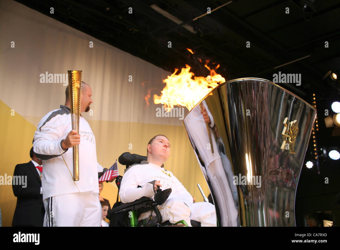 Manchester, UK. 23 June, 2012. Carl Tilson lights the Olympic beacon in ...