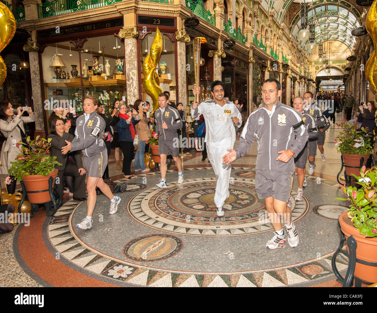 Olympic torch relay passing through the County Arcade in the Victoria ...