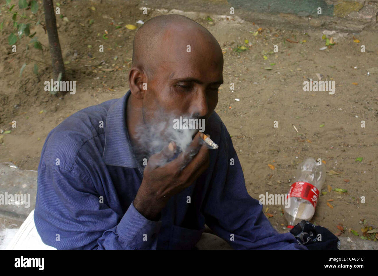 A Drug addict taking drug openly at a park while world celebrating ...