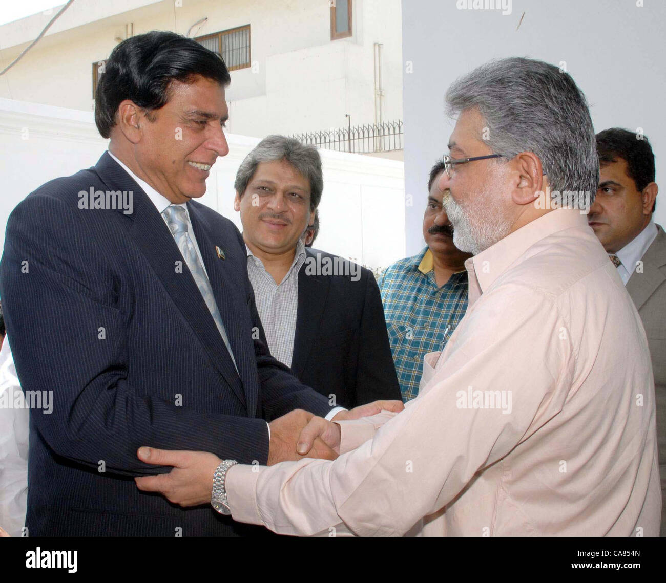 Prime Minister, Raja Pervez Ashraf shakes hand with Pir Sahib Pagara on ...