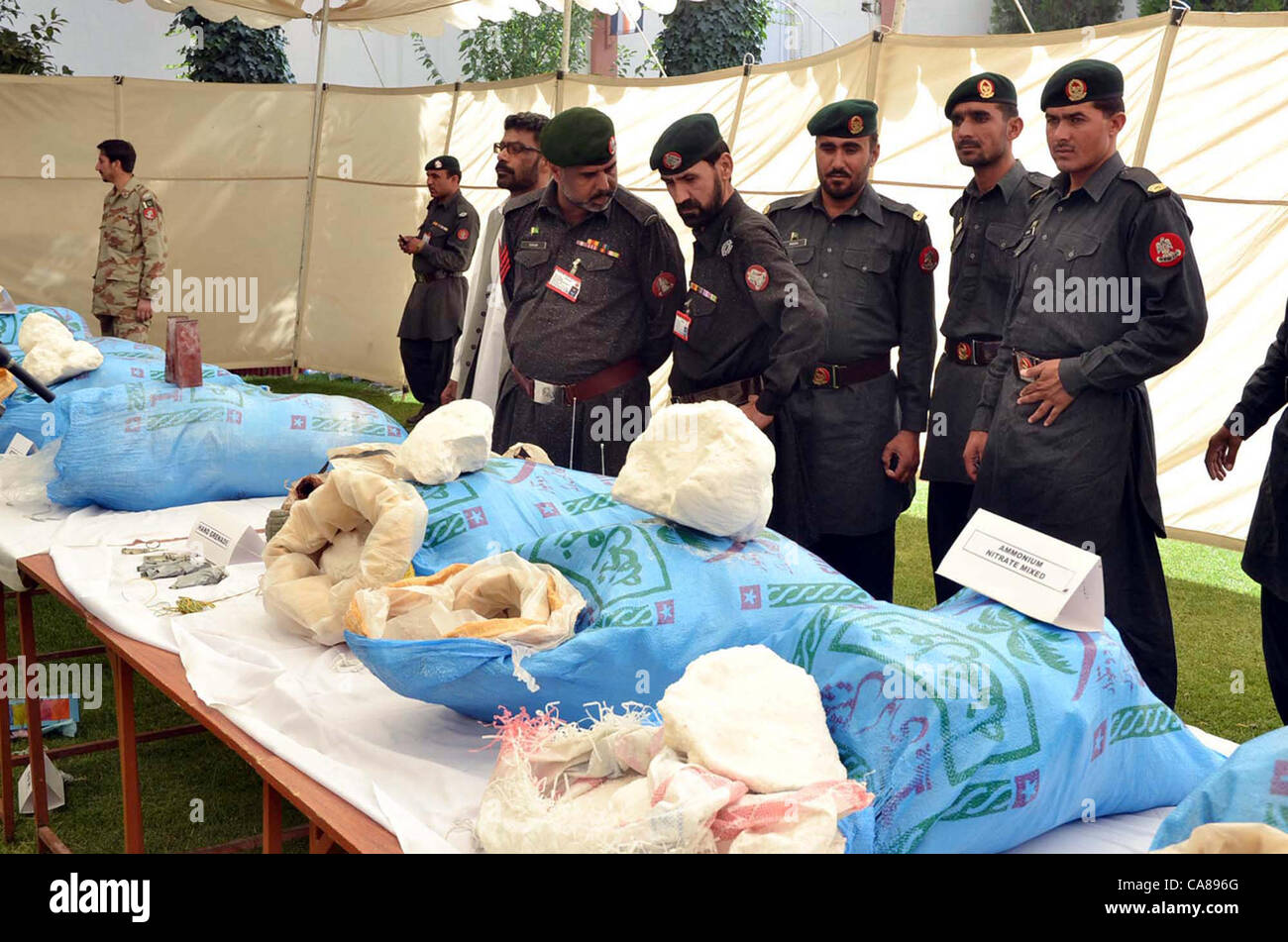 Frontier Constabulary (FC) official show seized weapons and explosive ...