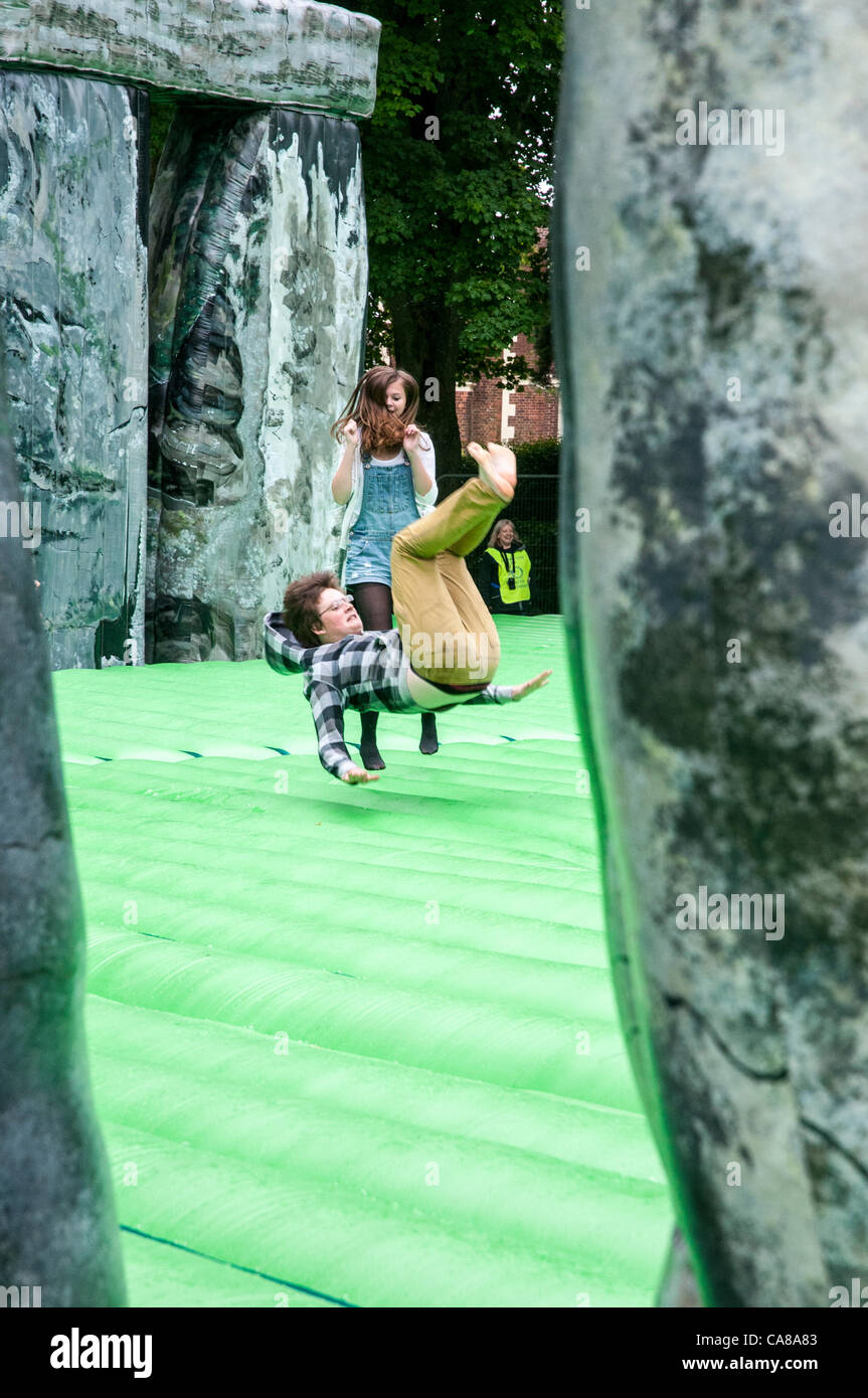 Teenager summersaulting on the life-sized inflatable replica of ...