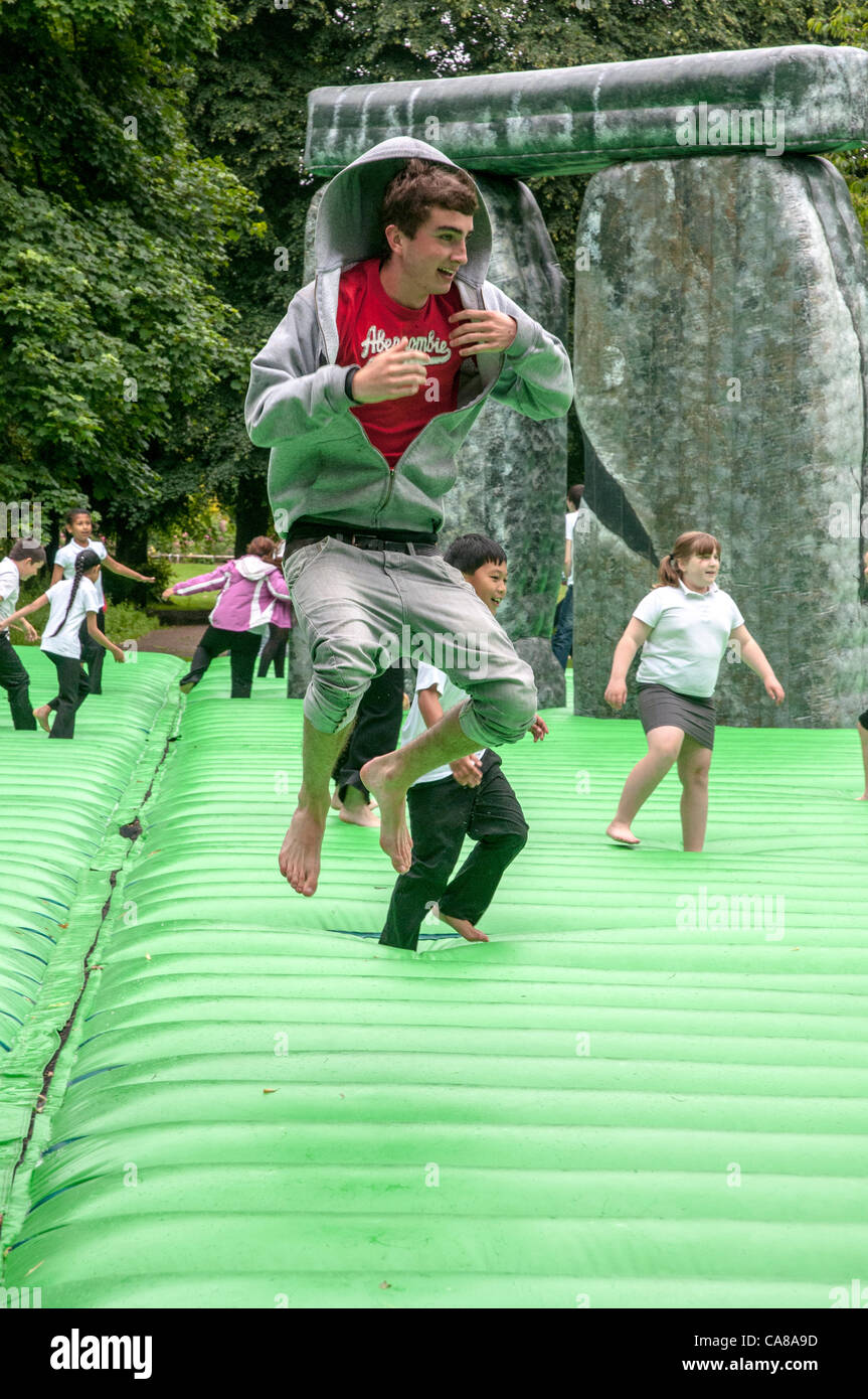 Teenager bouncing in the air on the life-sized inflatable replica of ...