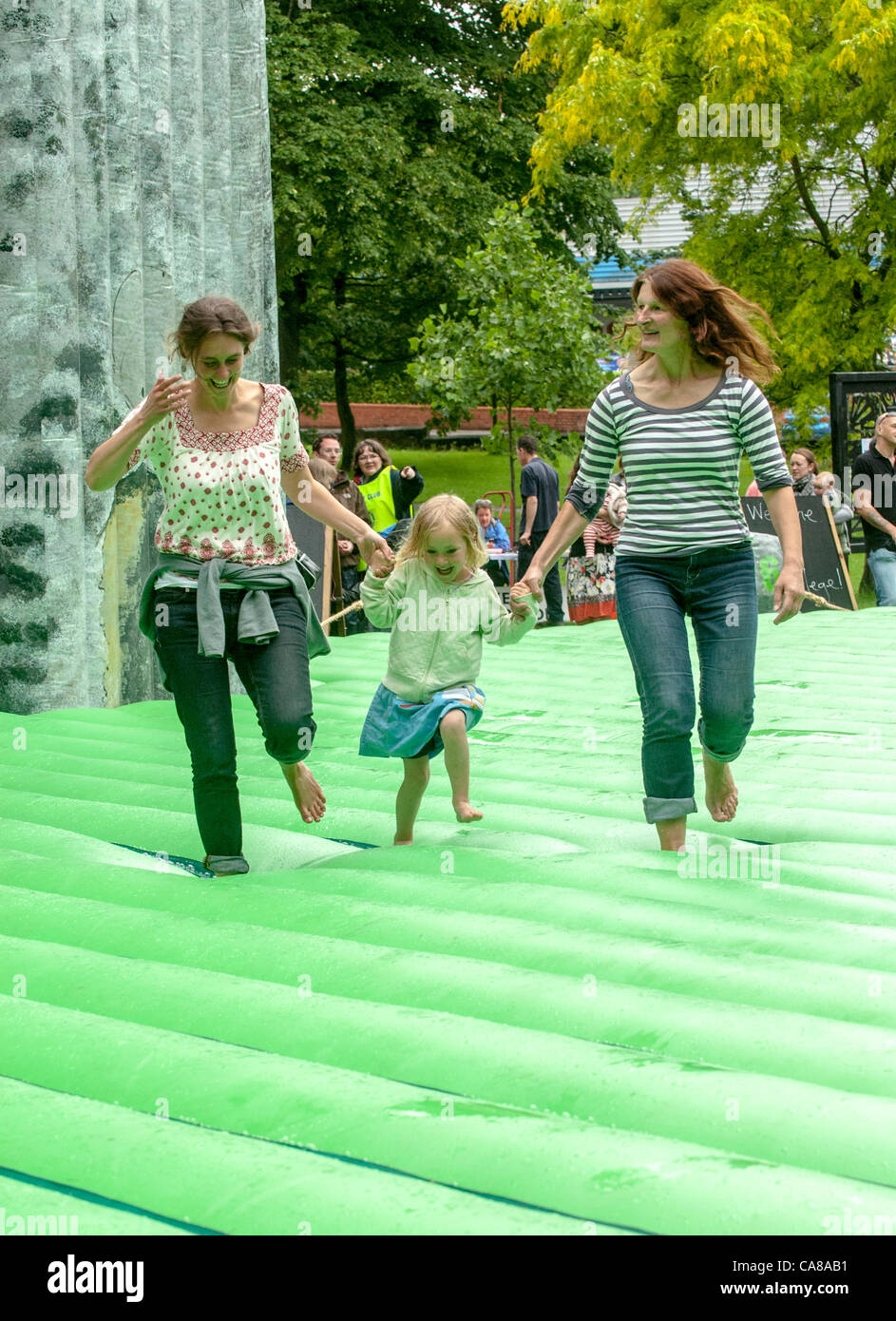A mother and child walk on the life-sized inflatable replica of ...