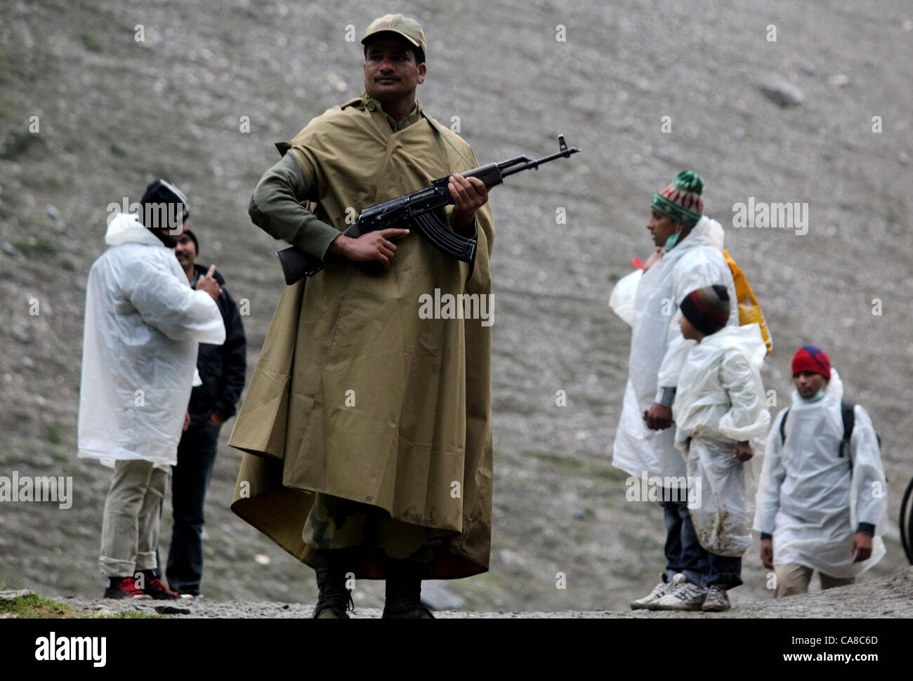 A indian securty personal stand guard as Hindu pilgrims trek to the ...