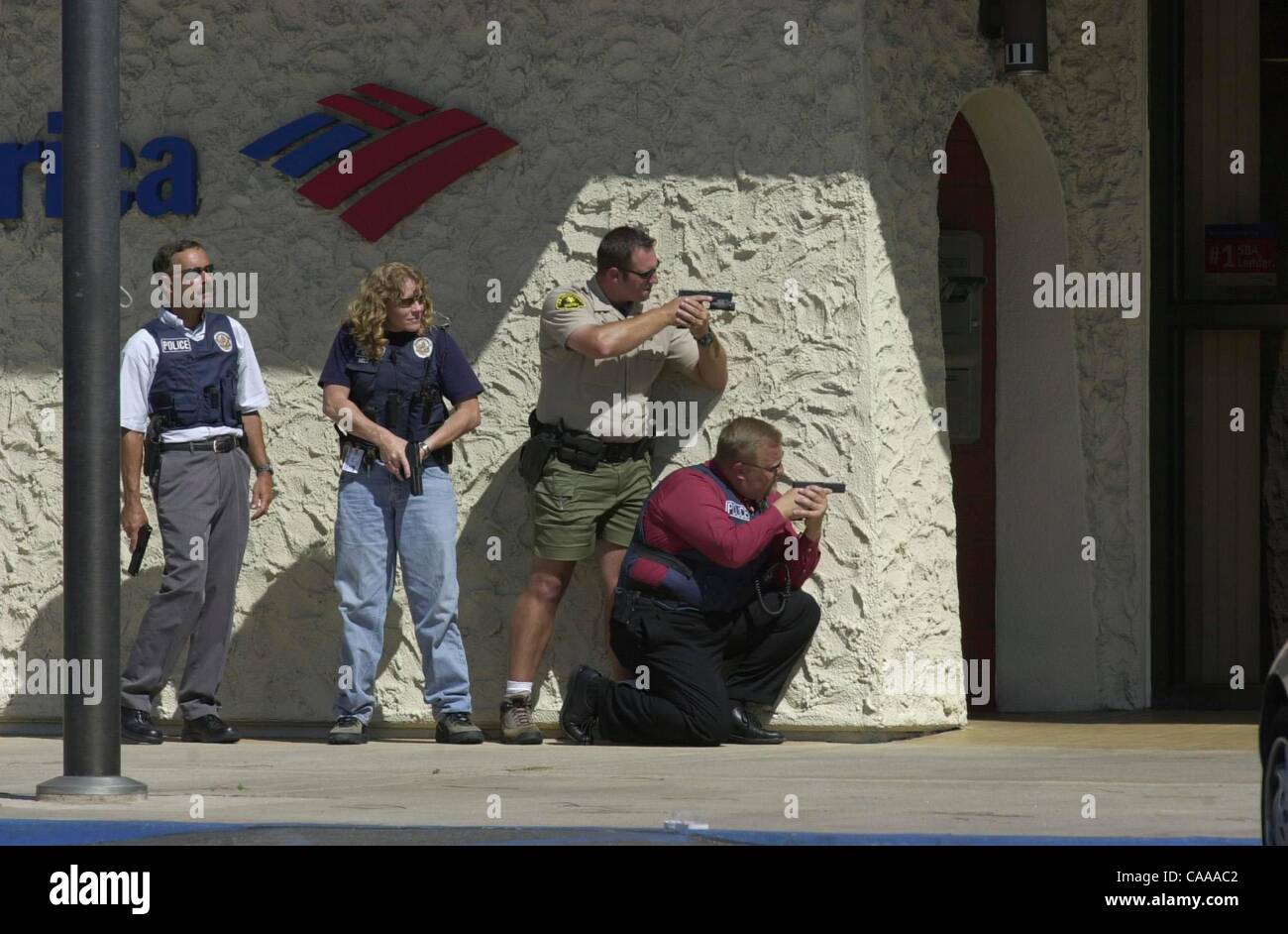 (Published 8/11/2004, NC-2; UTS1824778) Police officers watch one of ...