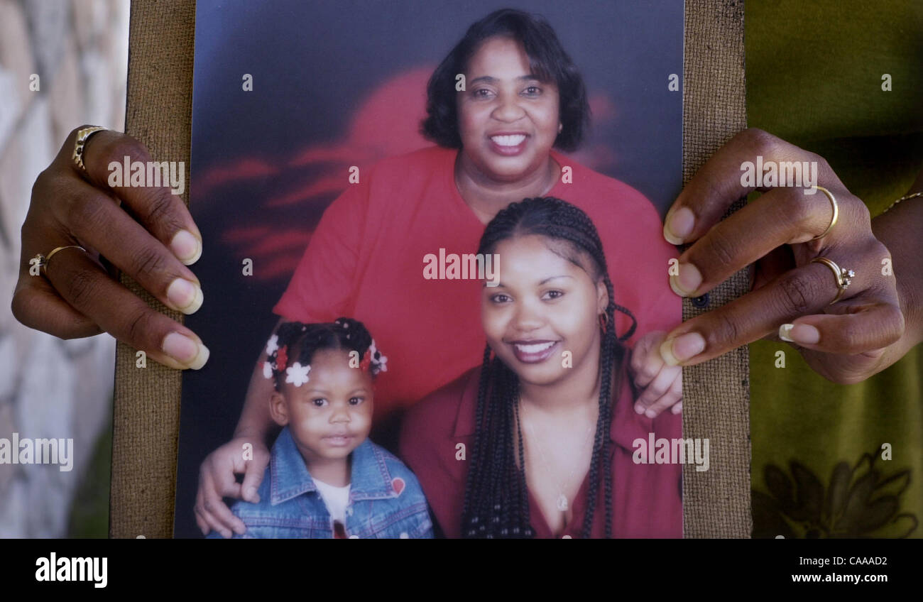 (Published 01/03/2003, B-1) A family member holds a family photo of ...