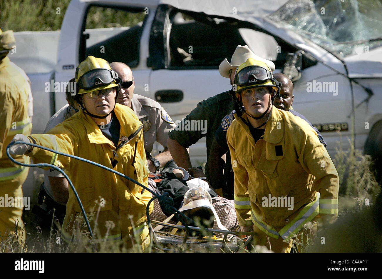 Rescue personel and CHP officers carry one of two passengers from a ...