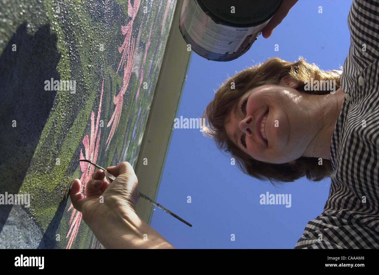 (Published 1/27/2005, B-1:2) Barbara Jacobson (cq) works on a mural at ...