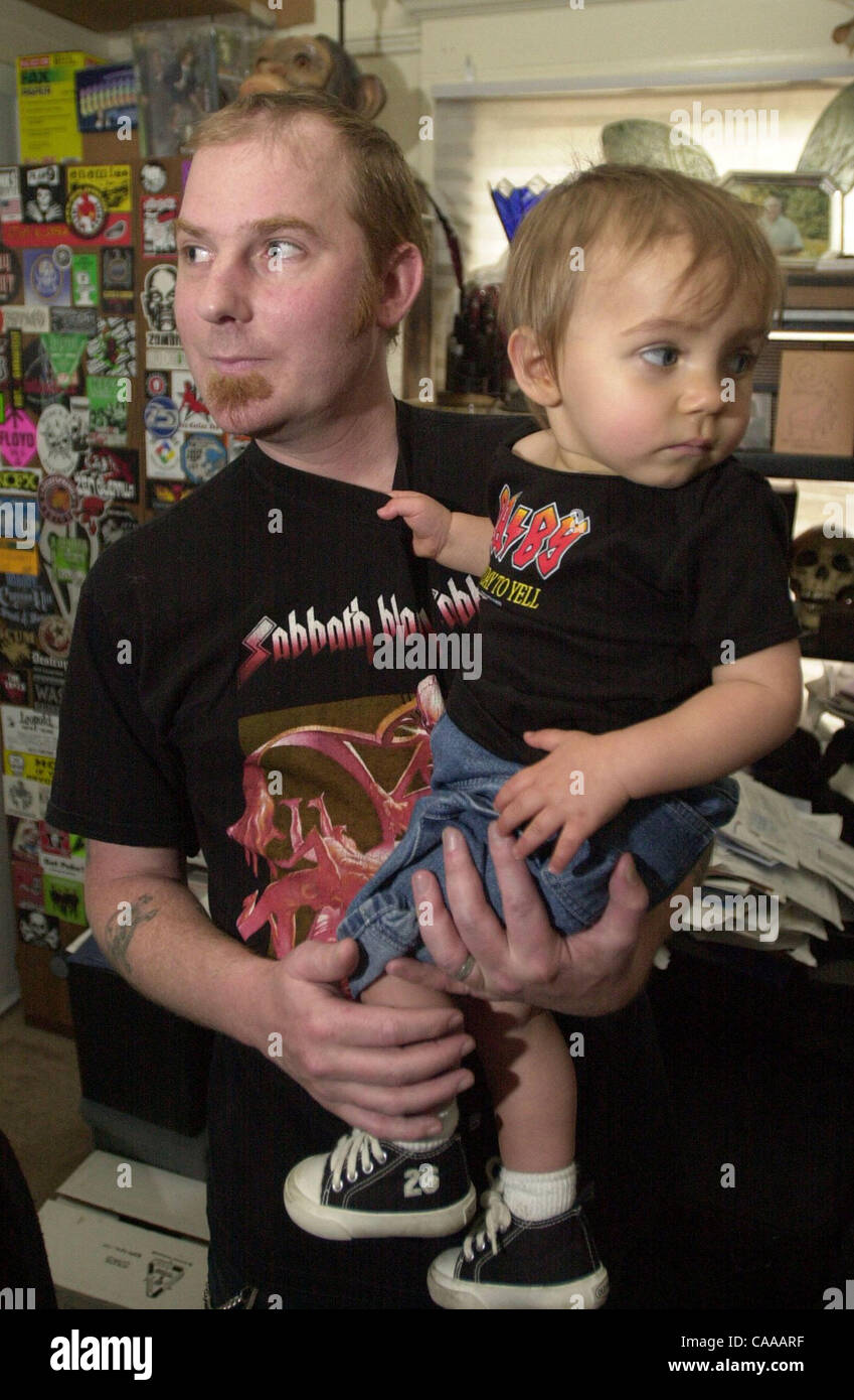 Mark DeVito a graffic artist in Berkeley California holds his 11 month ...