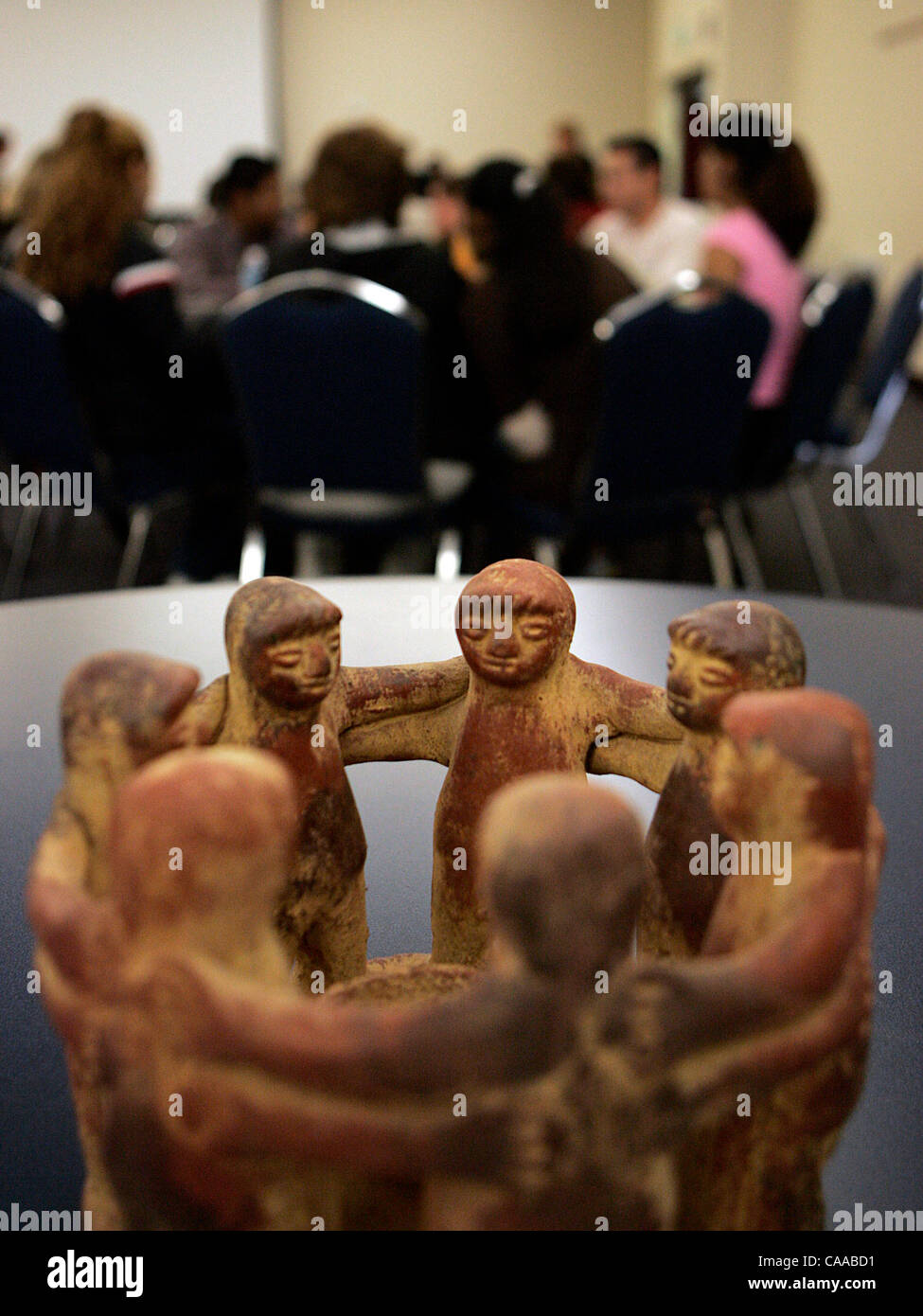 Clay figurines dancing together dot a table at the Binational ...