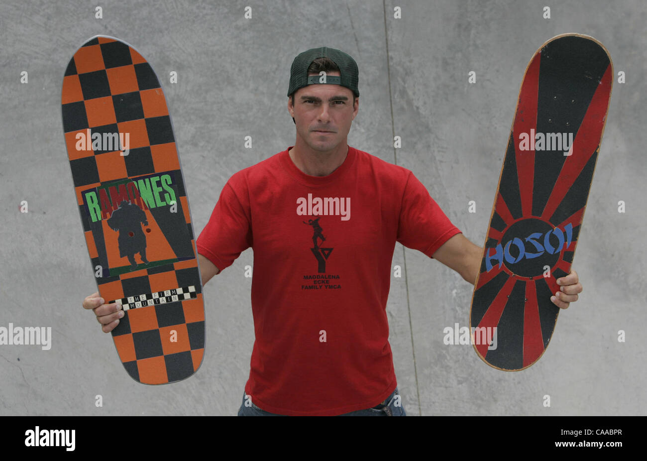 Marcelo Esposito holds two of his skateboard creations on Thursday at ...