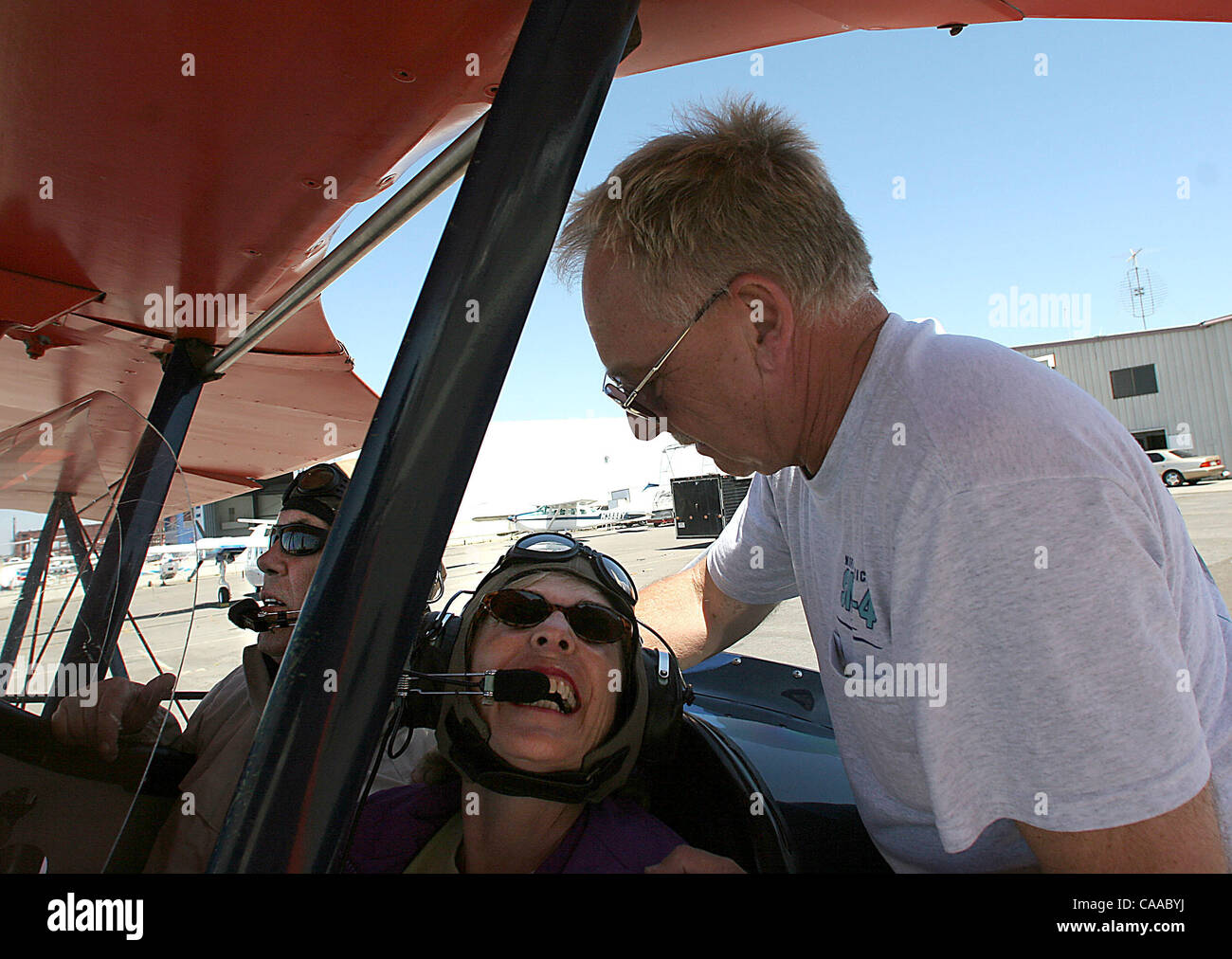 Biplane pilot Brian "BIggles" Shepherd, right, has a preflight talk ...