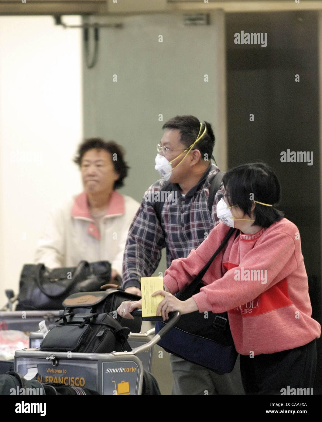 Apr 24, 2003; San Francisco, CA, USA; Passengers on a flight from Tapei ...