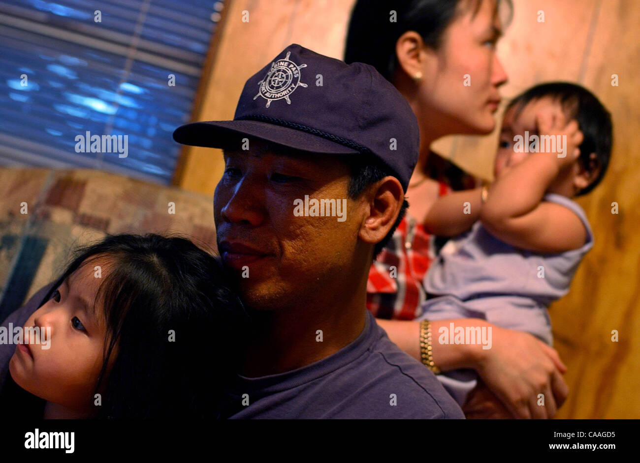Tina Tran, 3, from left, cuddles with her father Tu Tran as her mom ...