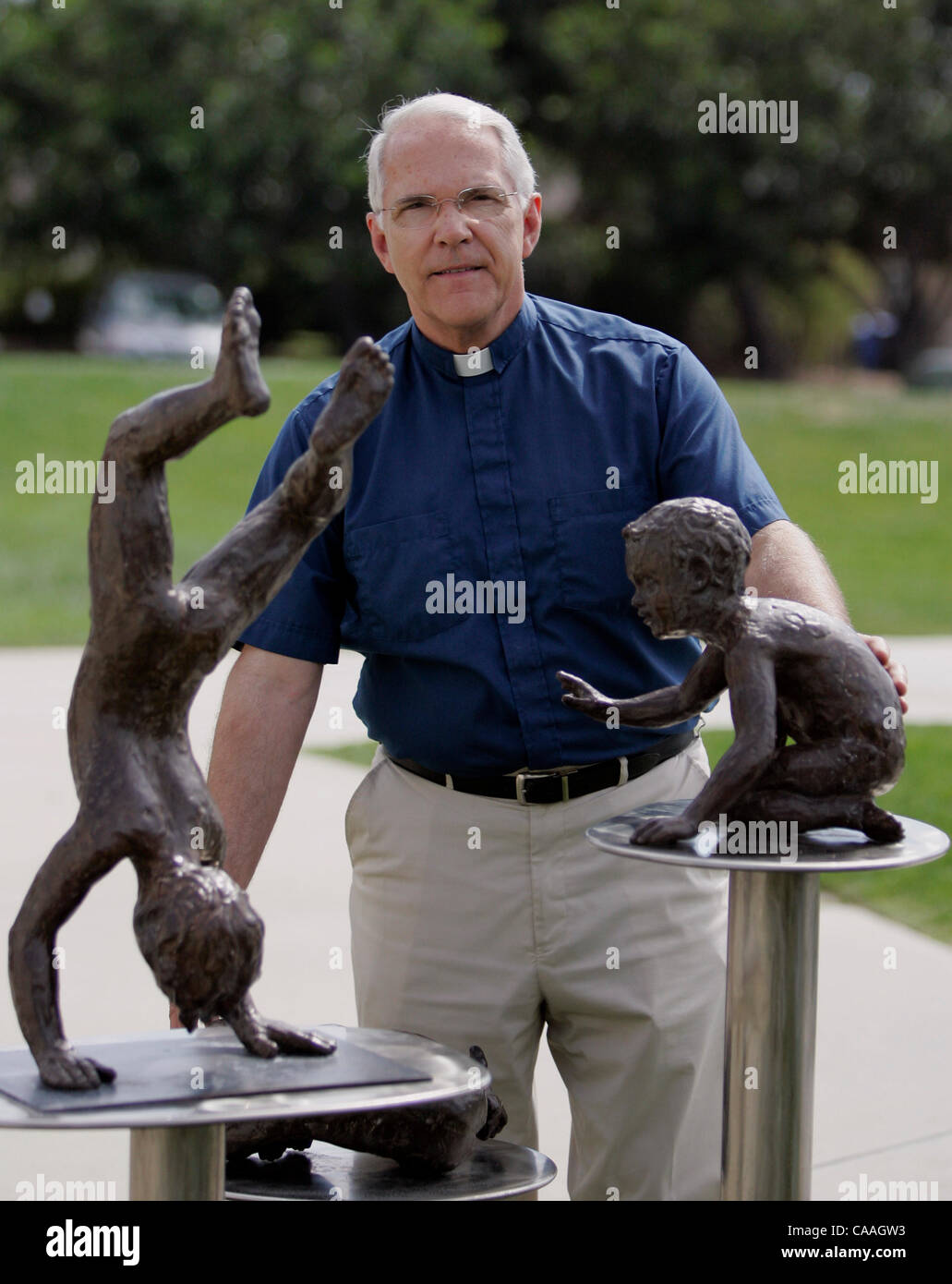 Pastor Bill Harman stands with one of the statues by sculptor Paul ...