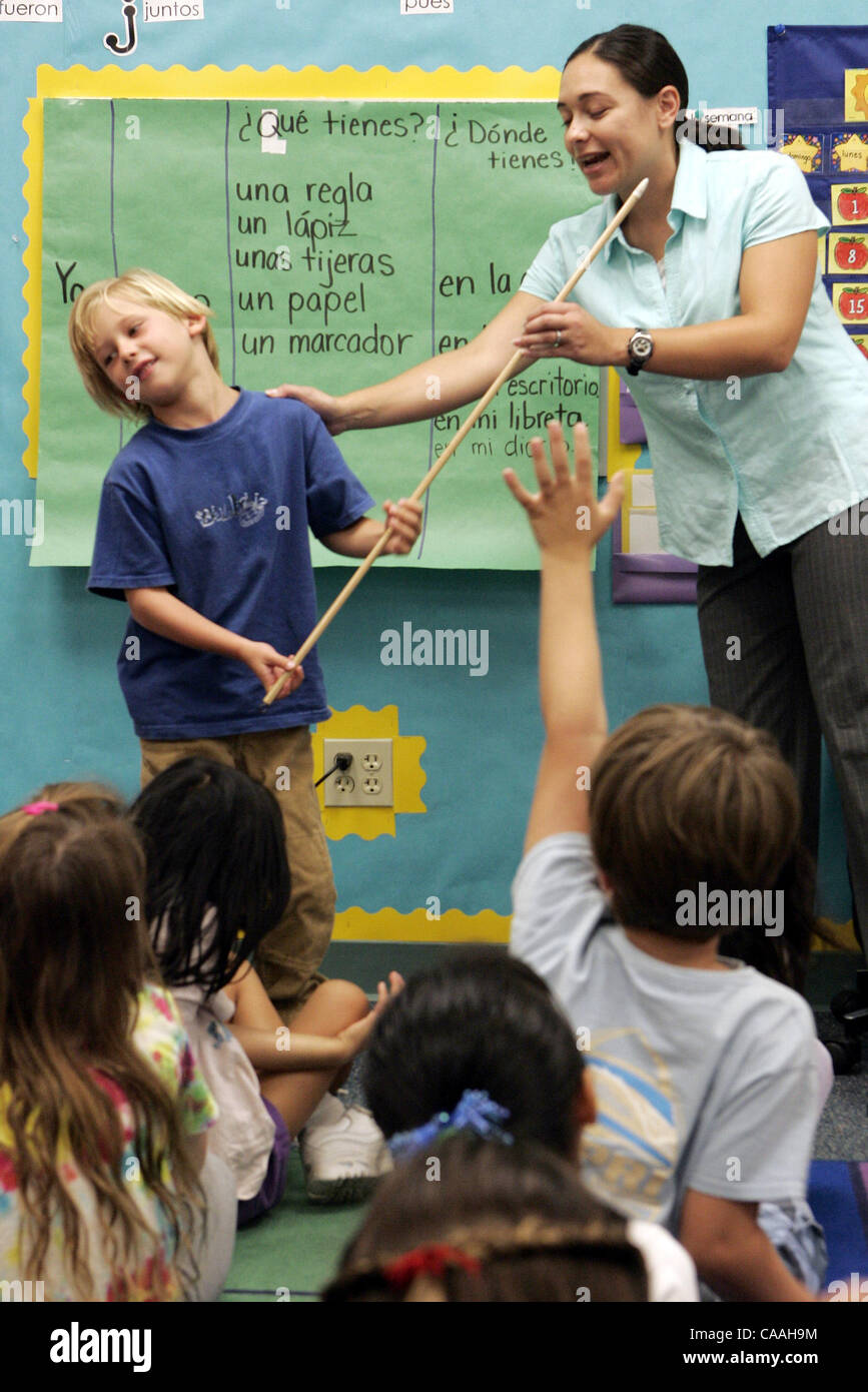Teacher Eloisa Bulow (right) congratulates 1st grader Gavin Kinney, 6 ...